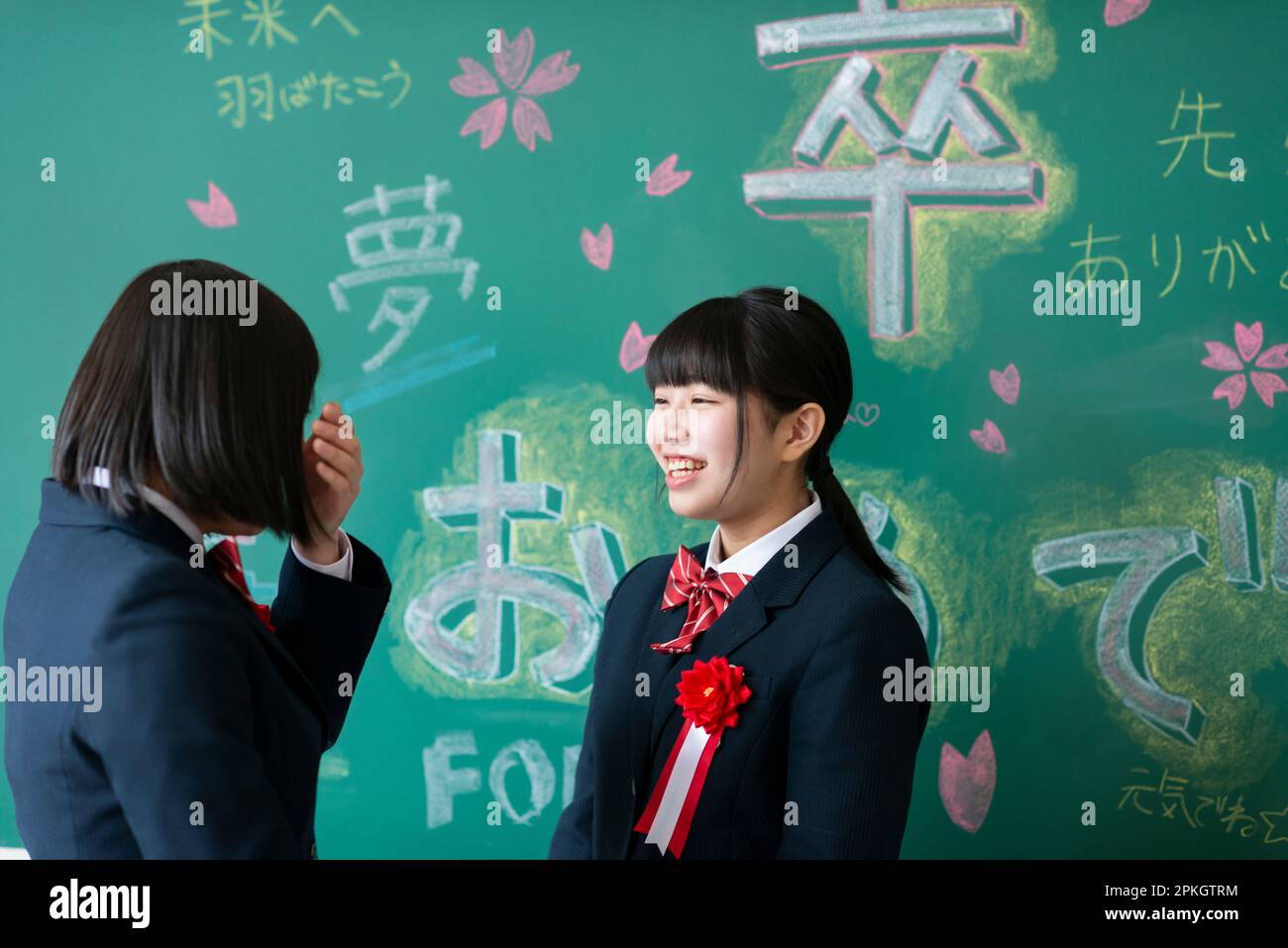 Female students facing each other in front of the blackboard Stock ...