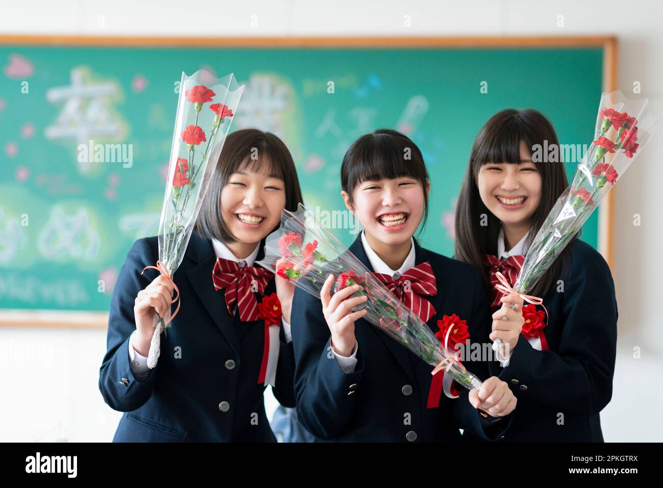 Female student holding flowers and smiling Stock Photo - Alamy