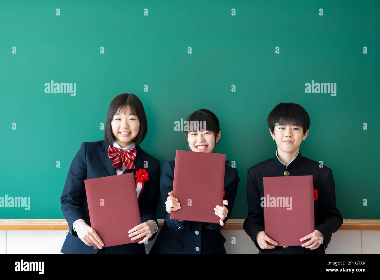 A student holding her diploma and smiling Stock Photo - Alamy