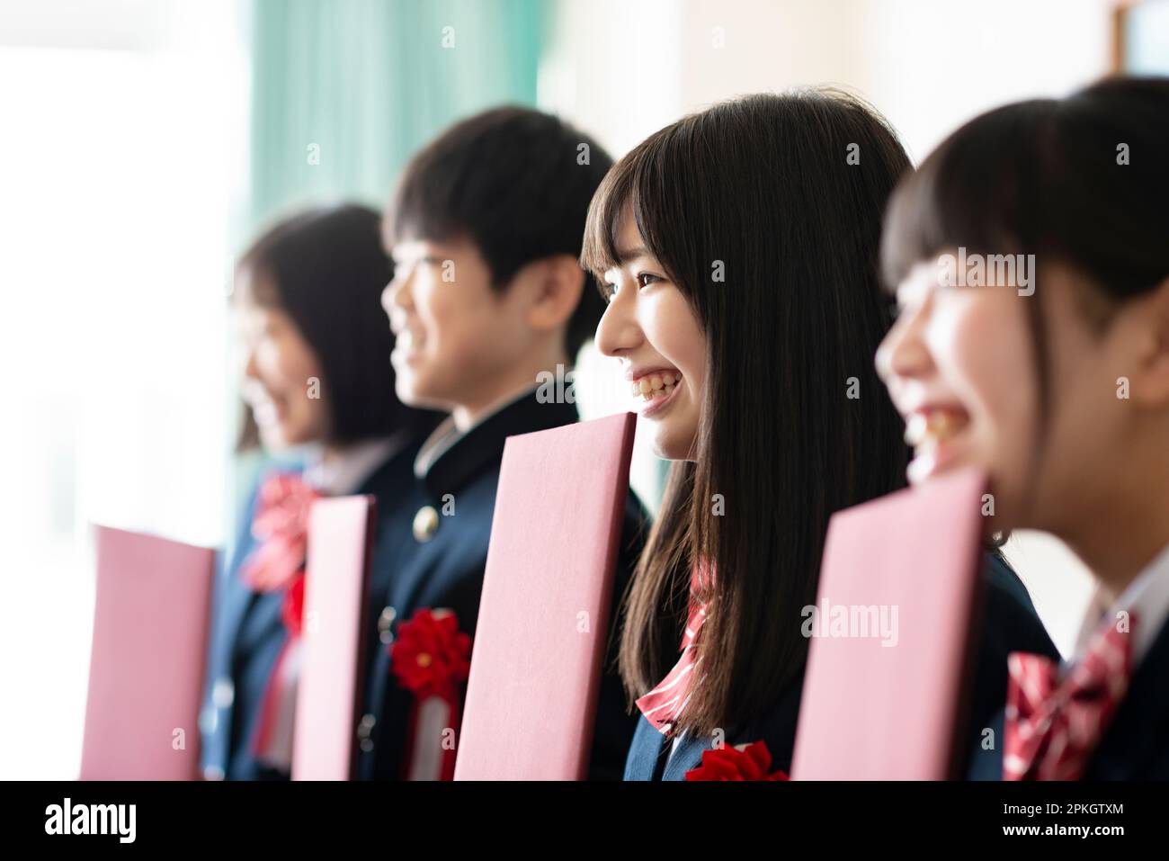 A smiling student holding her diploma Stock Photo - Alamy
