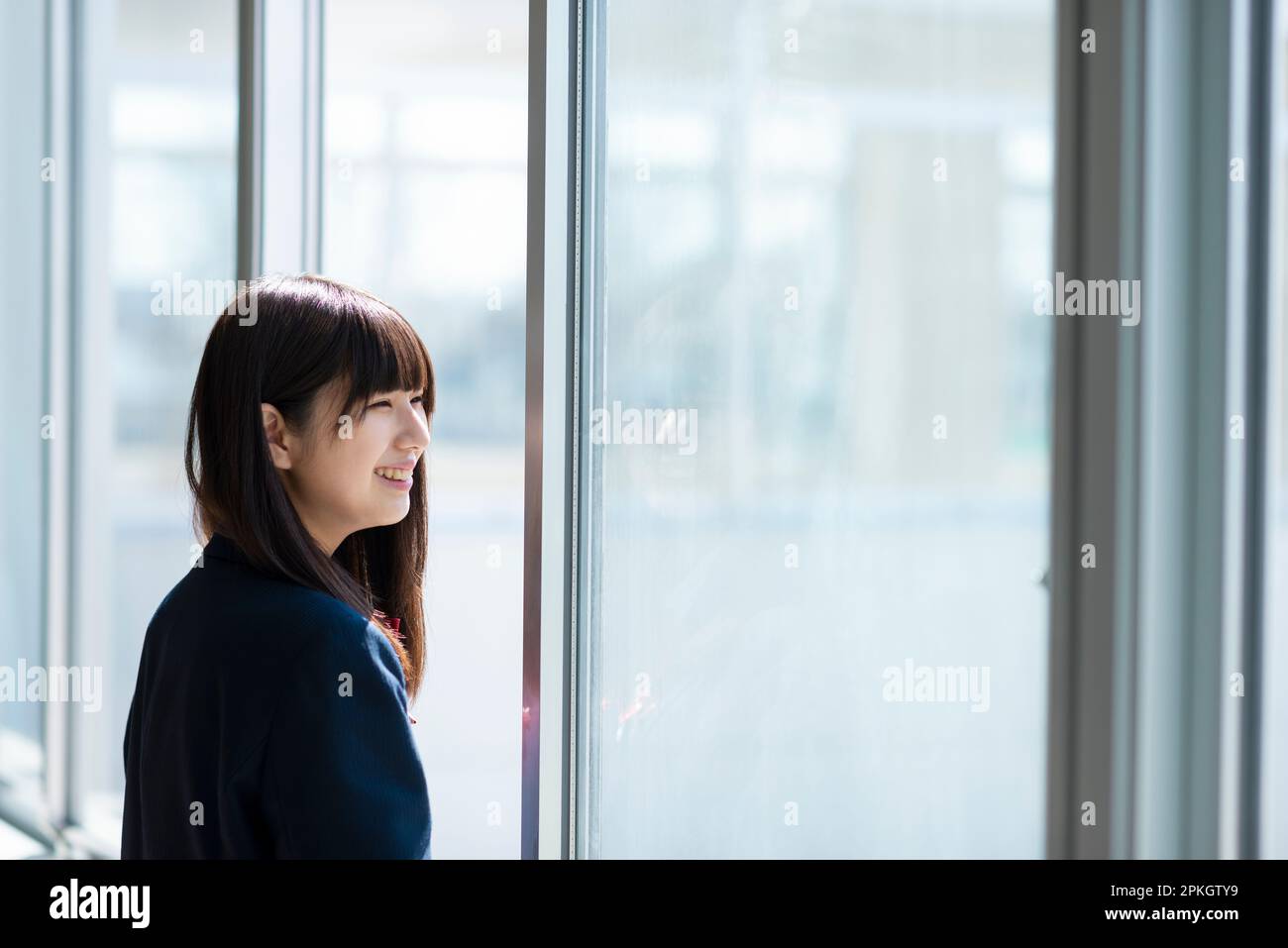 A female student smiling by the window Stock Photo - Alamy