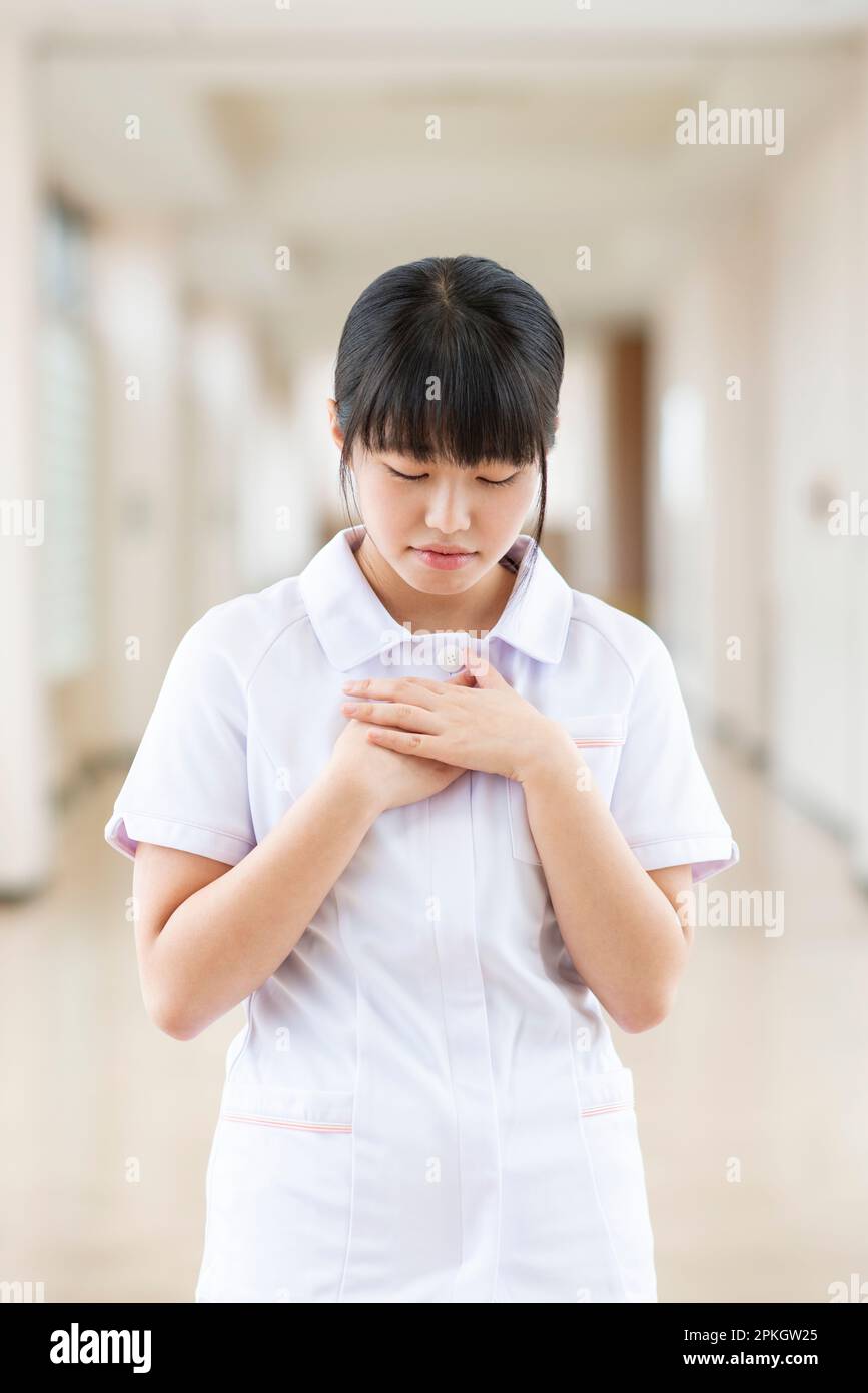 A nursing student putting her hand on her chest Stock Photo - Alamy