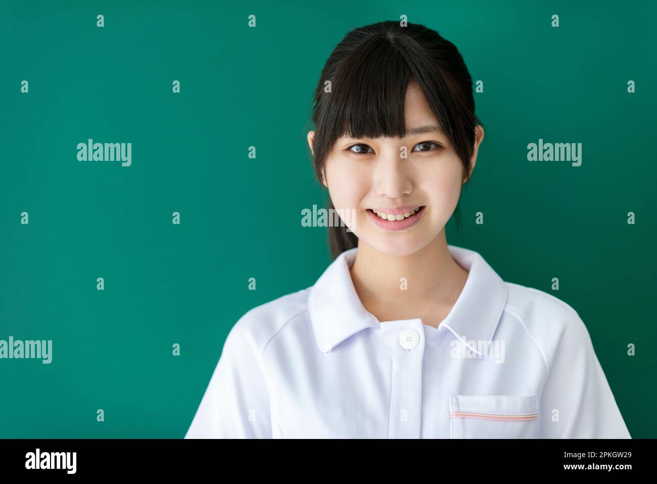 A smiling nursing student in front of the blackboard Stock Photo - Alamy