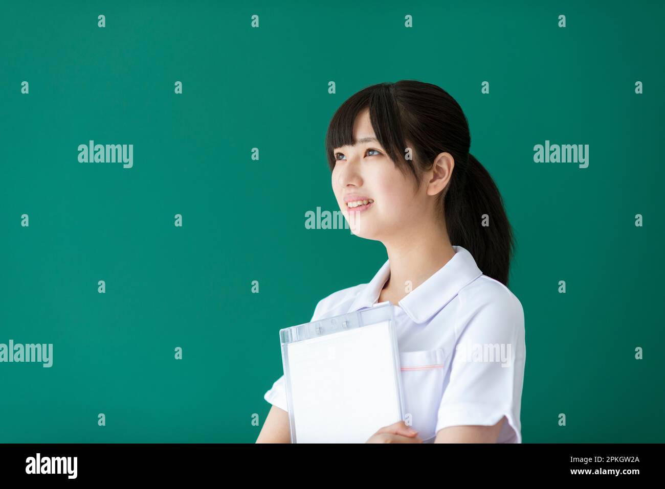 A smiling nursing student in front of the blackboard Stock Photo - Alamy