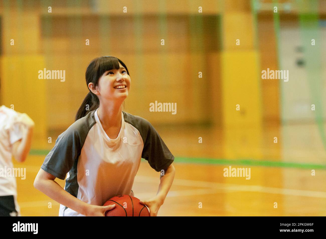 Female student playing basketball in gymnasium Stock Photo - Alamy