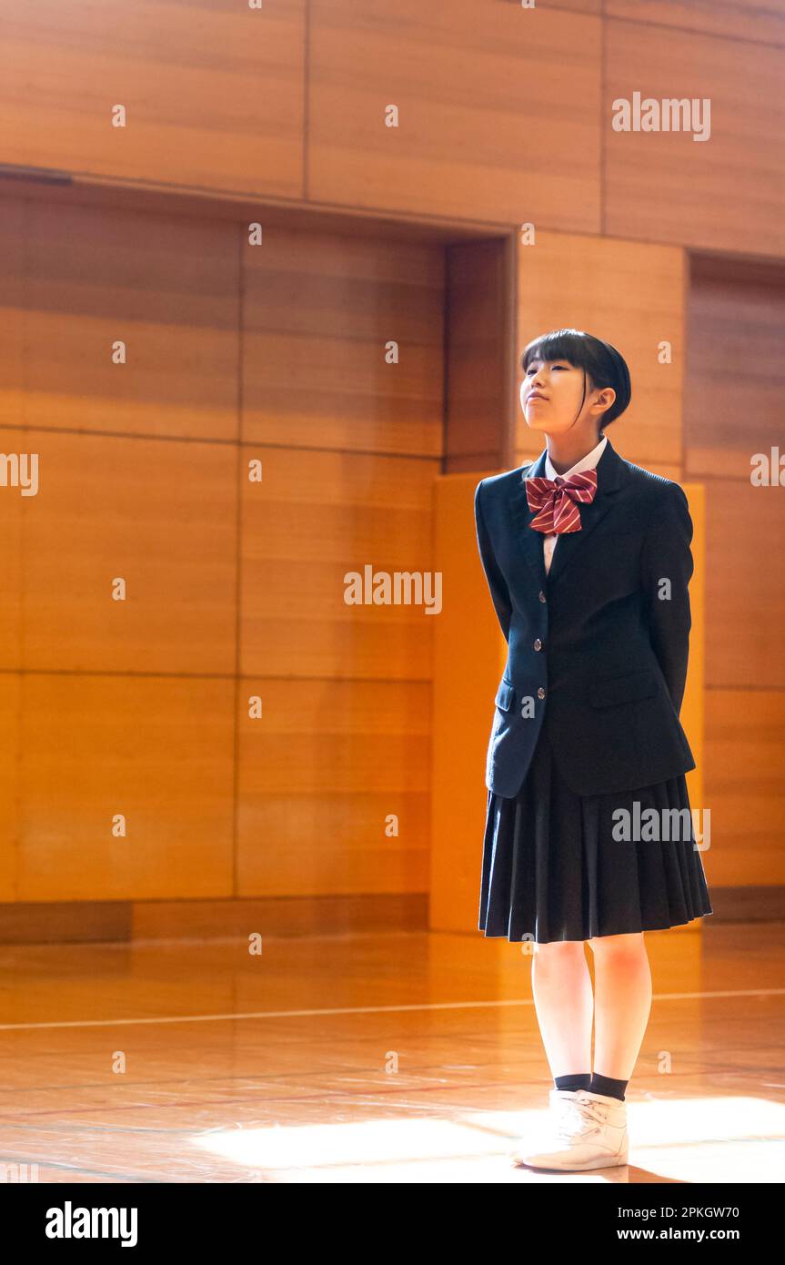 A female student standing in the gymnasium Stock Photo - Alamy