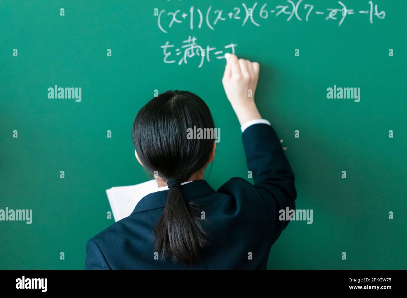 Female student solving a problem on the blackboard Stock Photo - Alamy