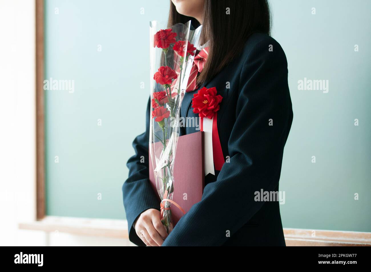 A female student holding her diploma and flowers Stock Photo - Alamy