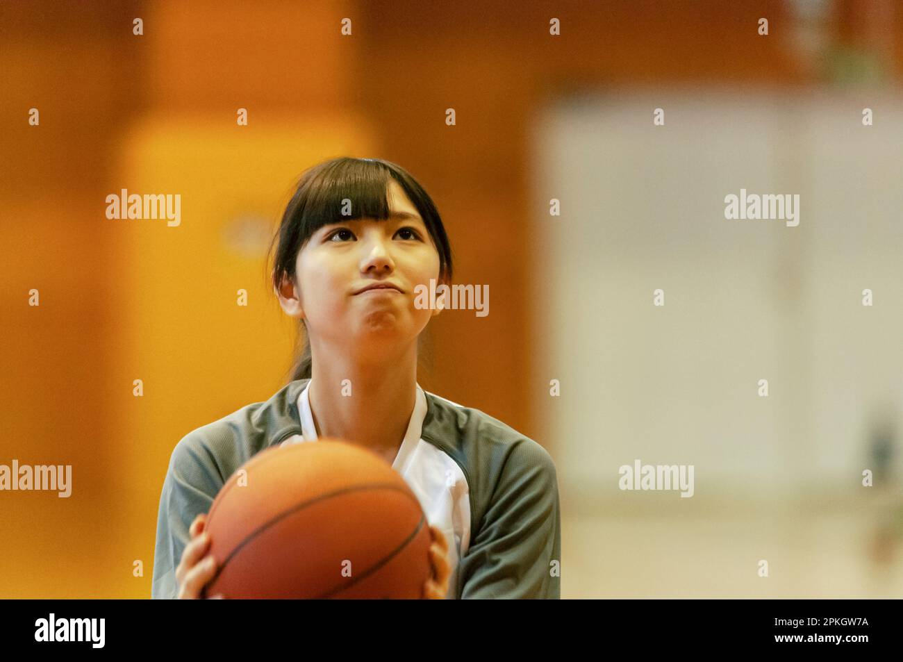 Female student playing basketball in gymnasium Stock Photo - Alamy