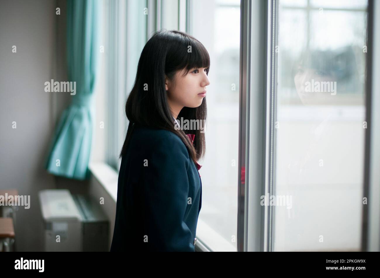 Female student looking outside in class Stock Photo - Alamy