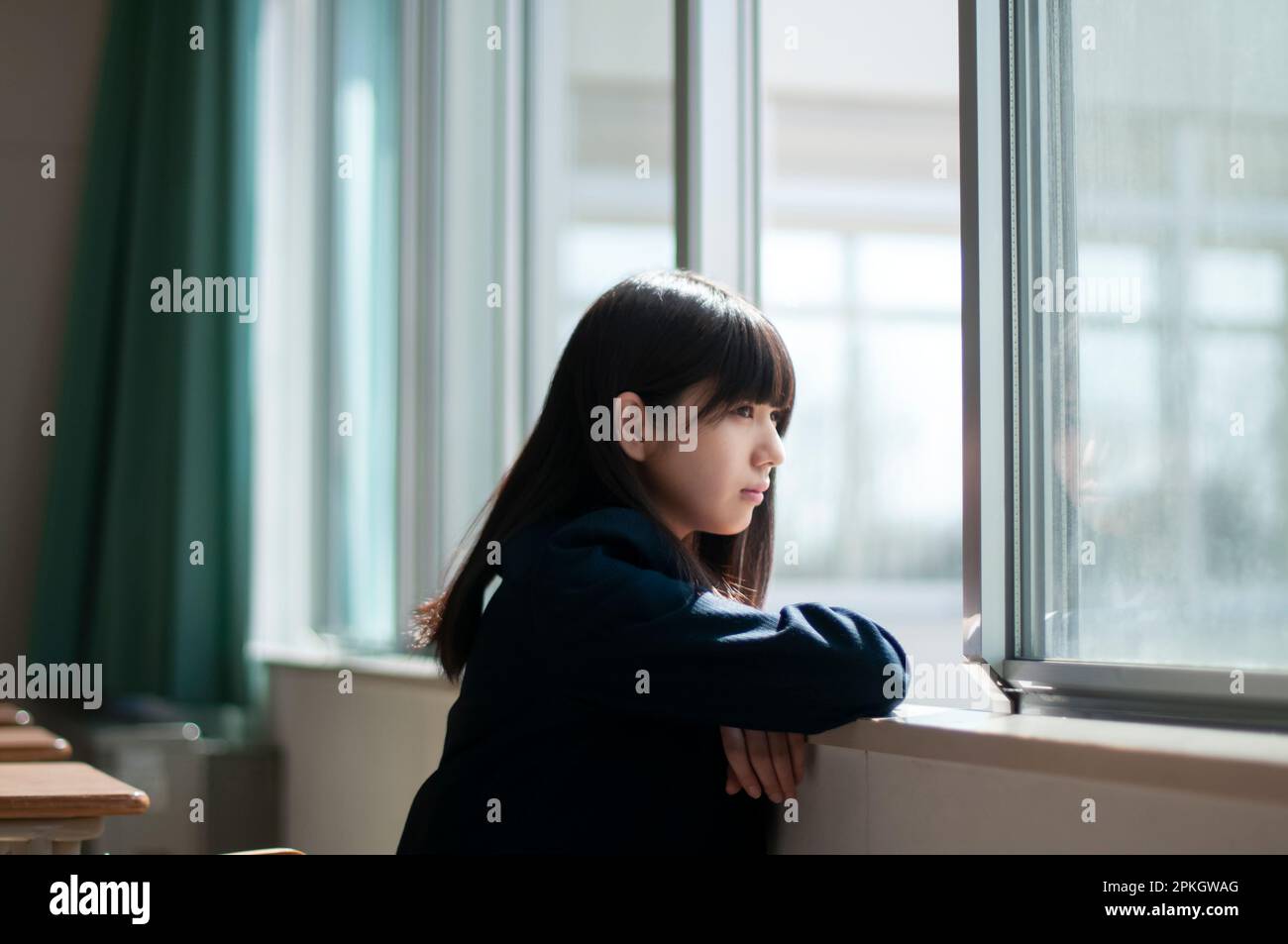 Female student looking outside in a classroom Stock Photo - Alamy