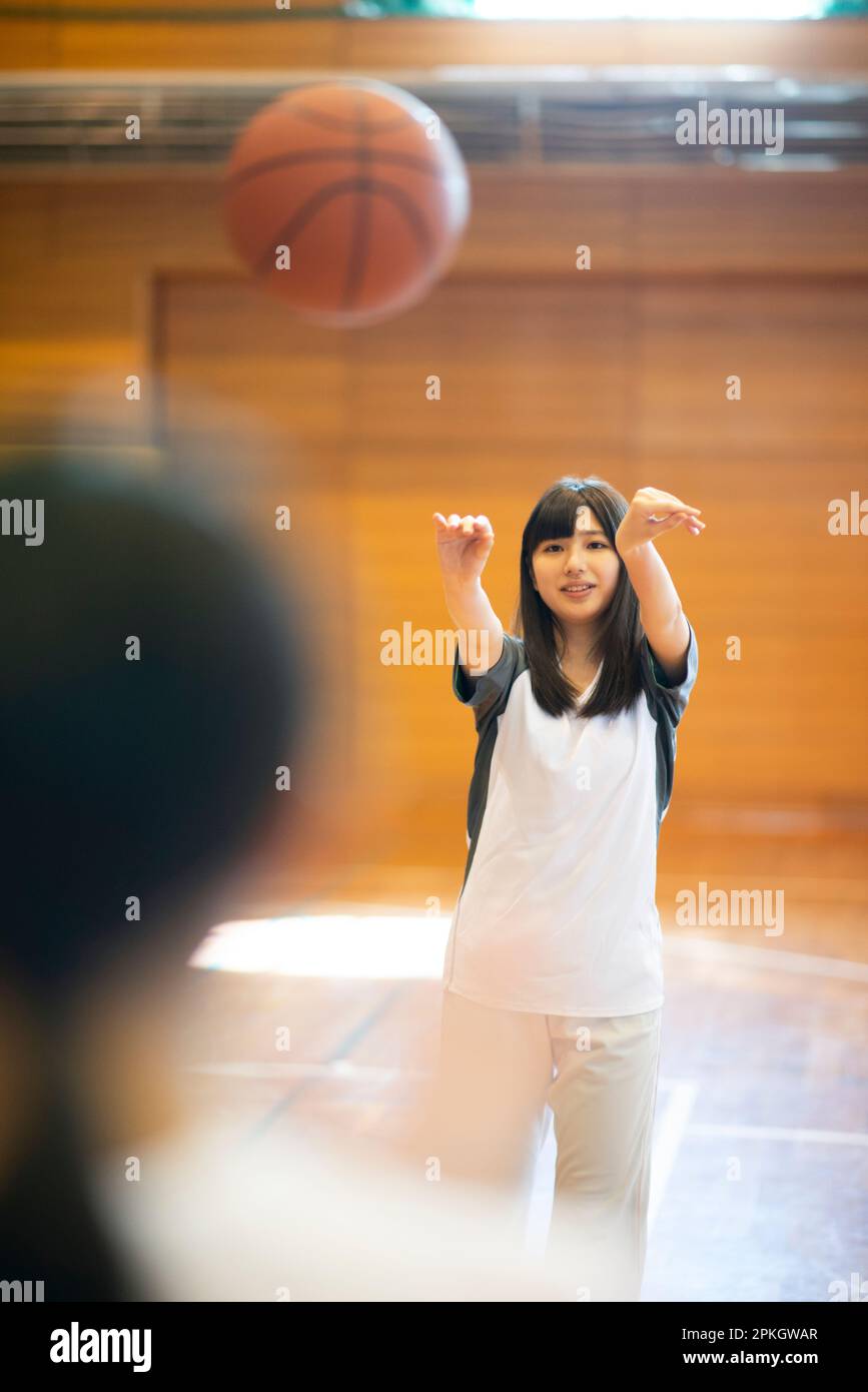 Female student playing basketball in the gym Stock Photo - Alamy