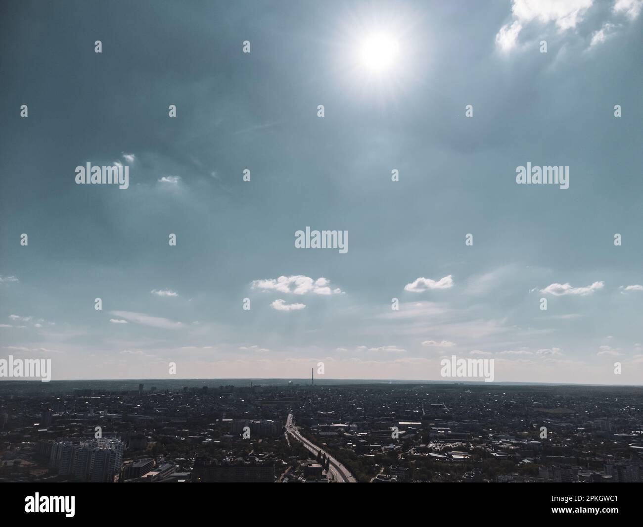 Aerial view on moody city streets with sun in sky. Urban landscape view ...