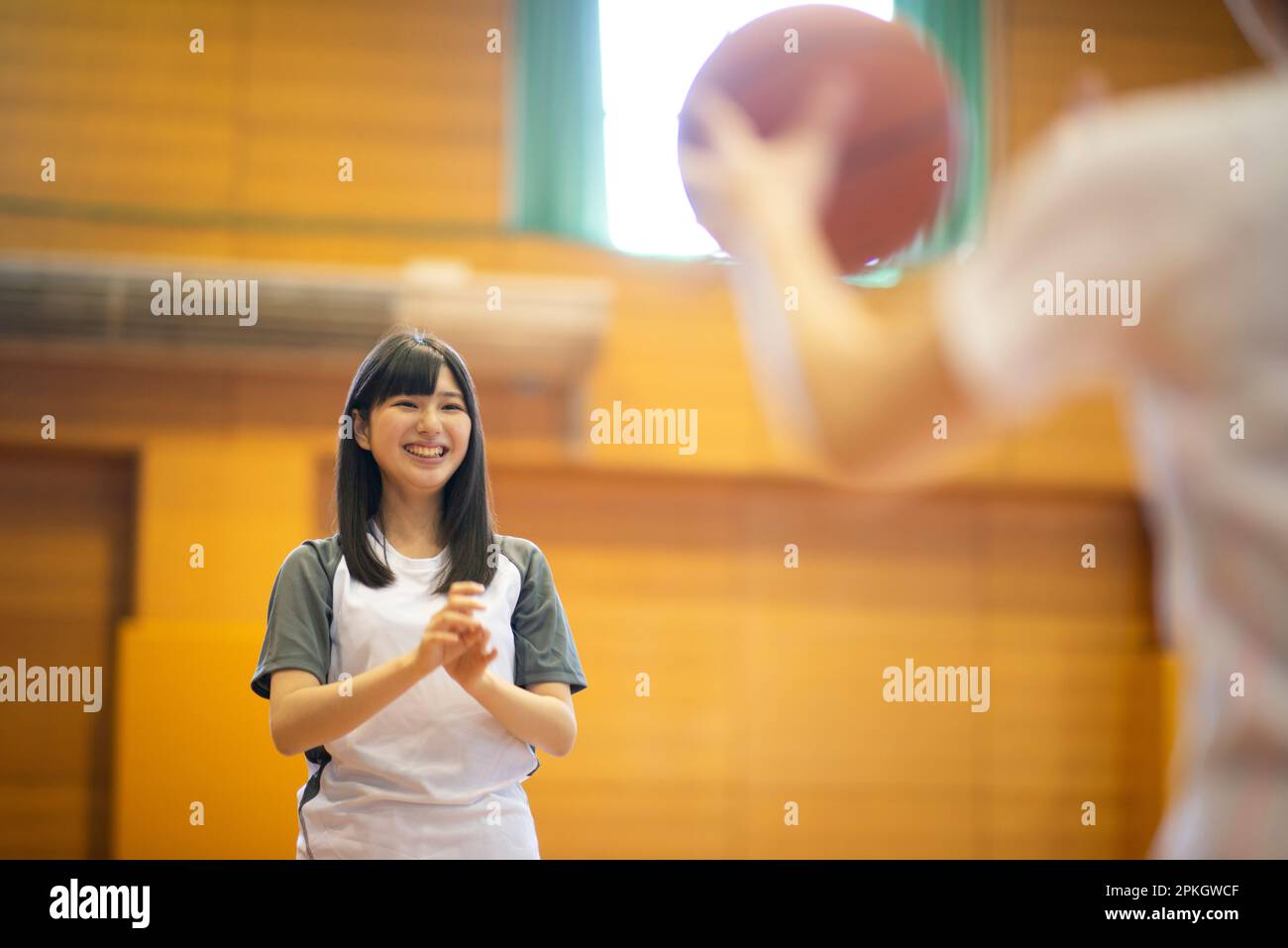 Female student playing basketball in gymnasium Stock Photo - Alamy