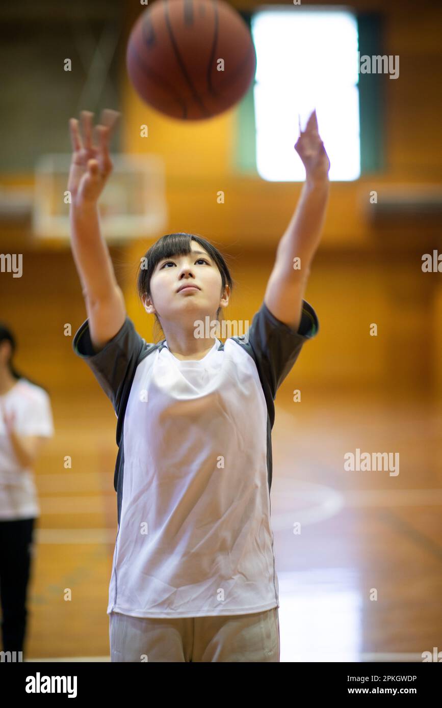 Female student playing basketball in the gym Stock Photo - Alamy
