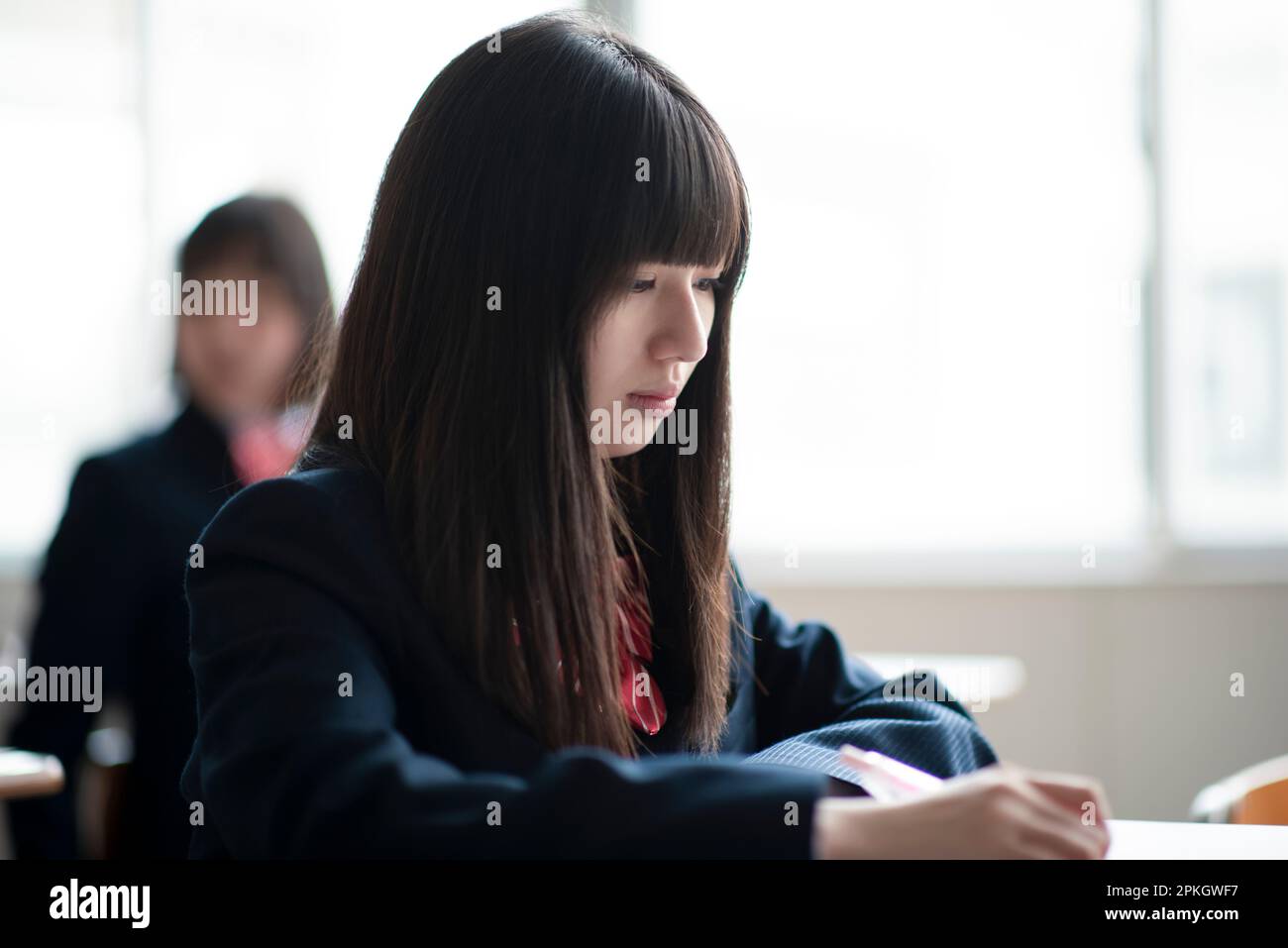 Female student taking a class in the classroom Stock Photo - Alamy