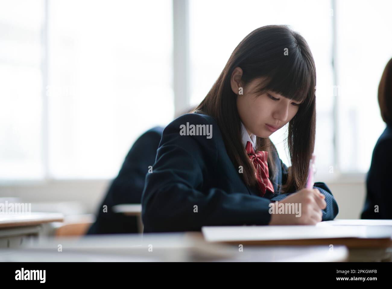 A female student taking a class in a classroom Stock Photo - Alamy