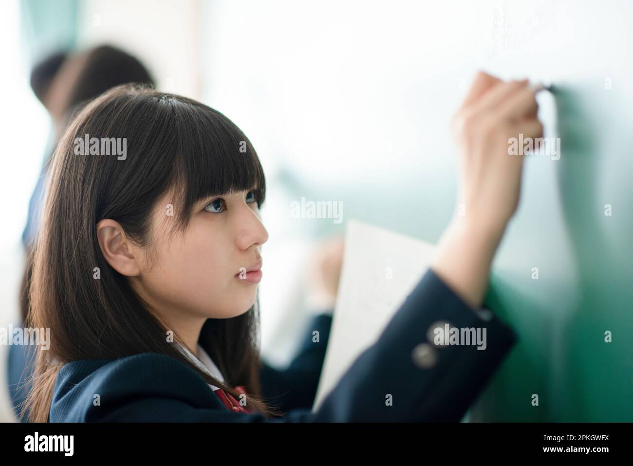 Female student writing answers on the blackboard with chalk Stock Photo ...