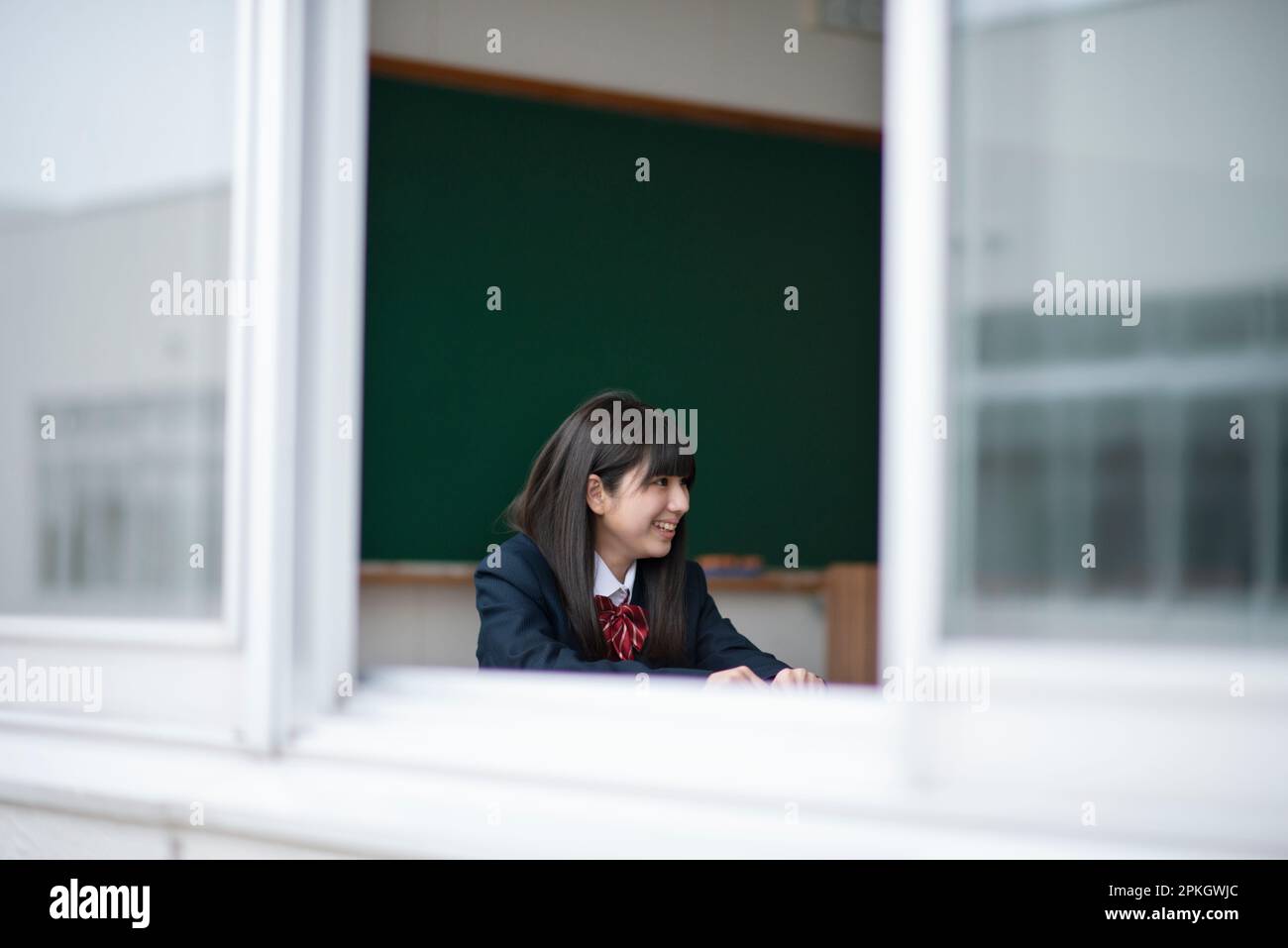 Female student smiling in the classroom Stock Photo - Alamy