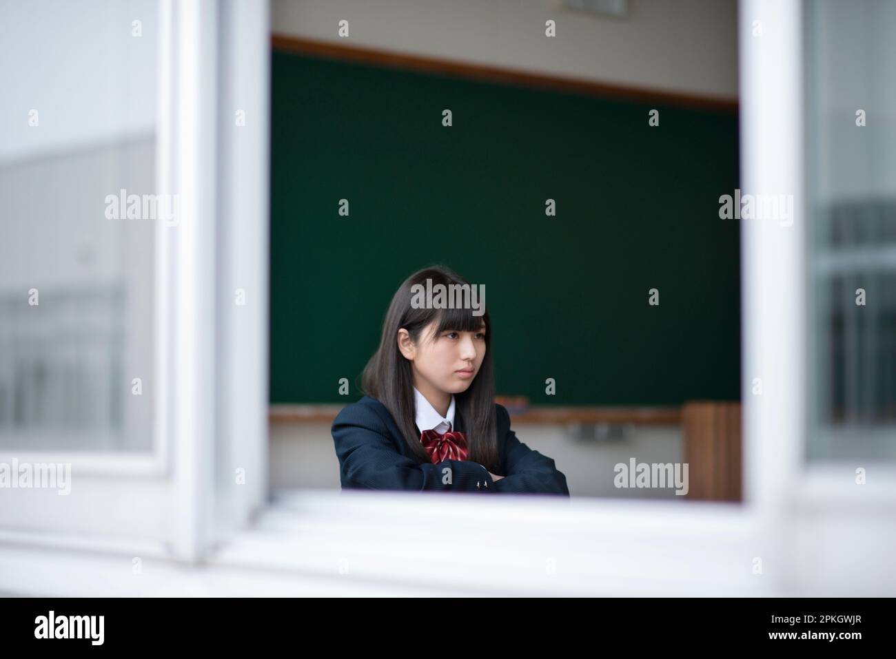 A female student making a serious face in the classroom Stock Photo - Alamy