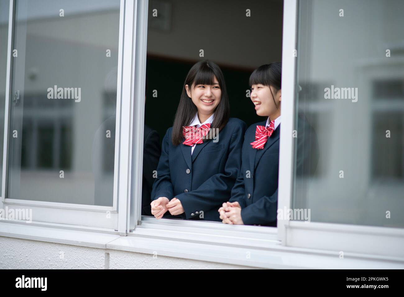 Female student chatting at the window Stock Photo - Alamy