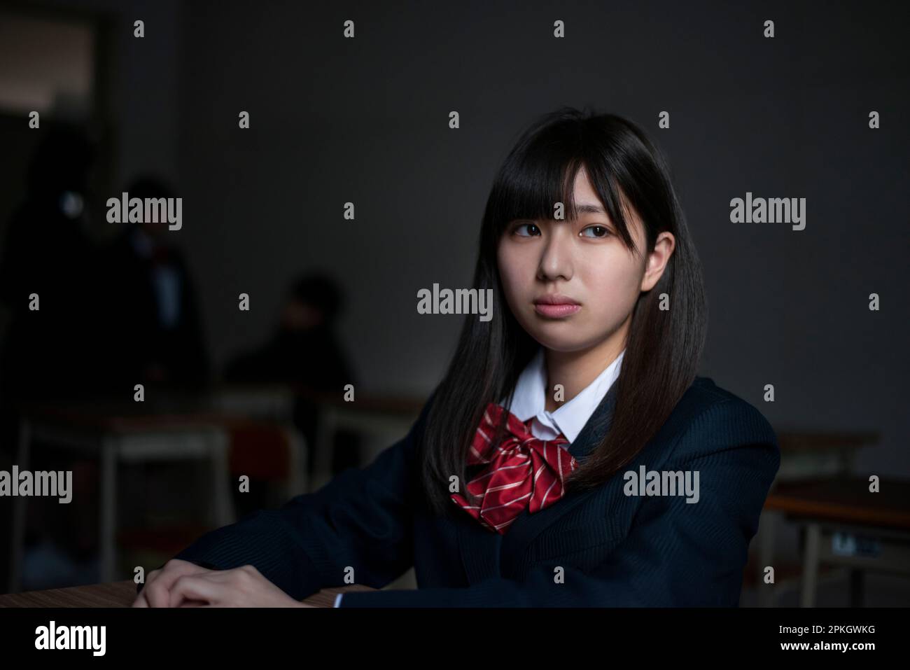 A female student making a serious face in a classroom Stock Photo - Alamy