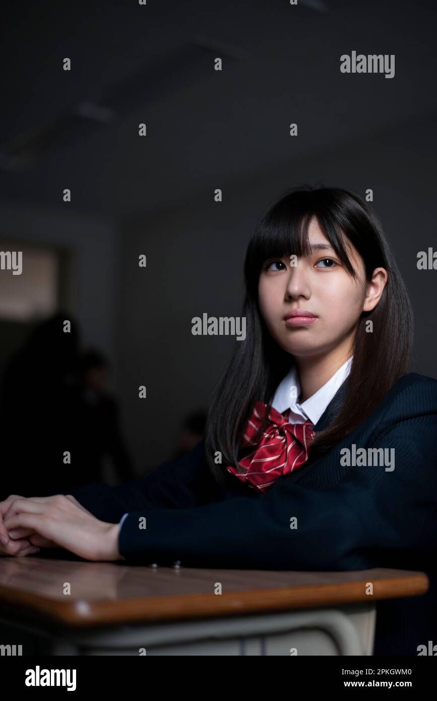 A female student making a serious face in a classroom Stock Photo - Alamy