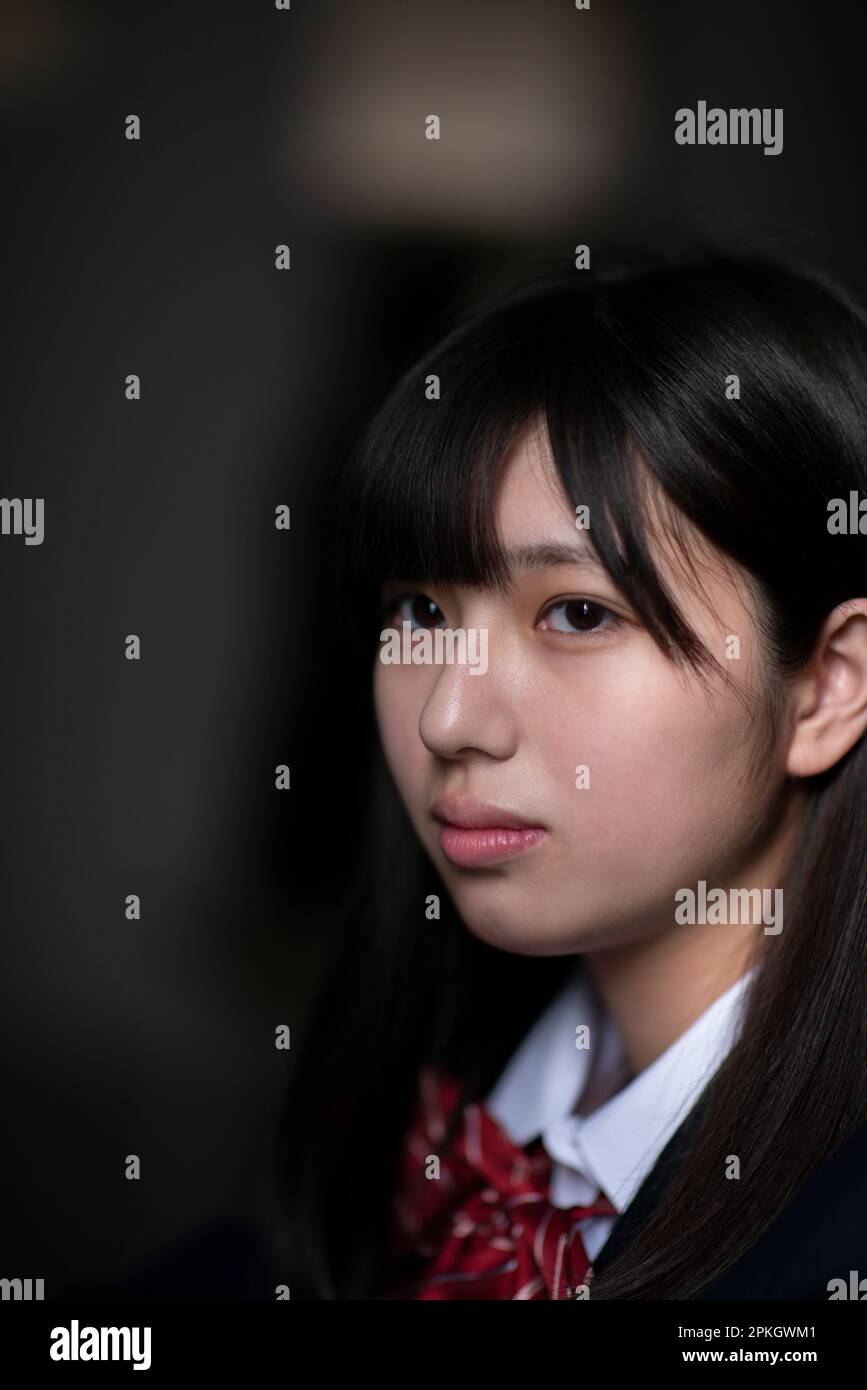 A female student making a serious face in a classroom Stock Photo - Alamy