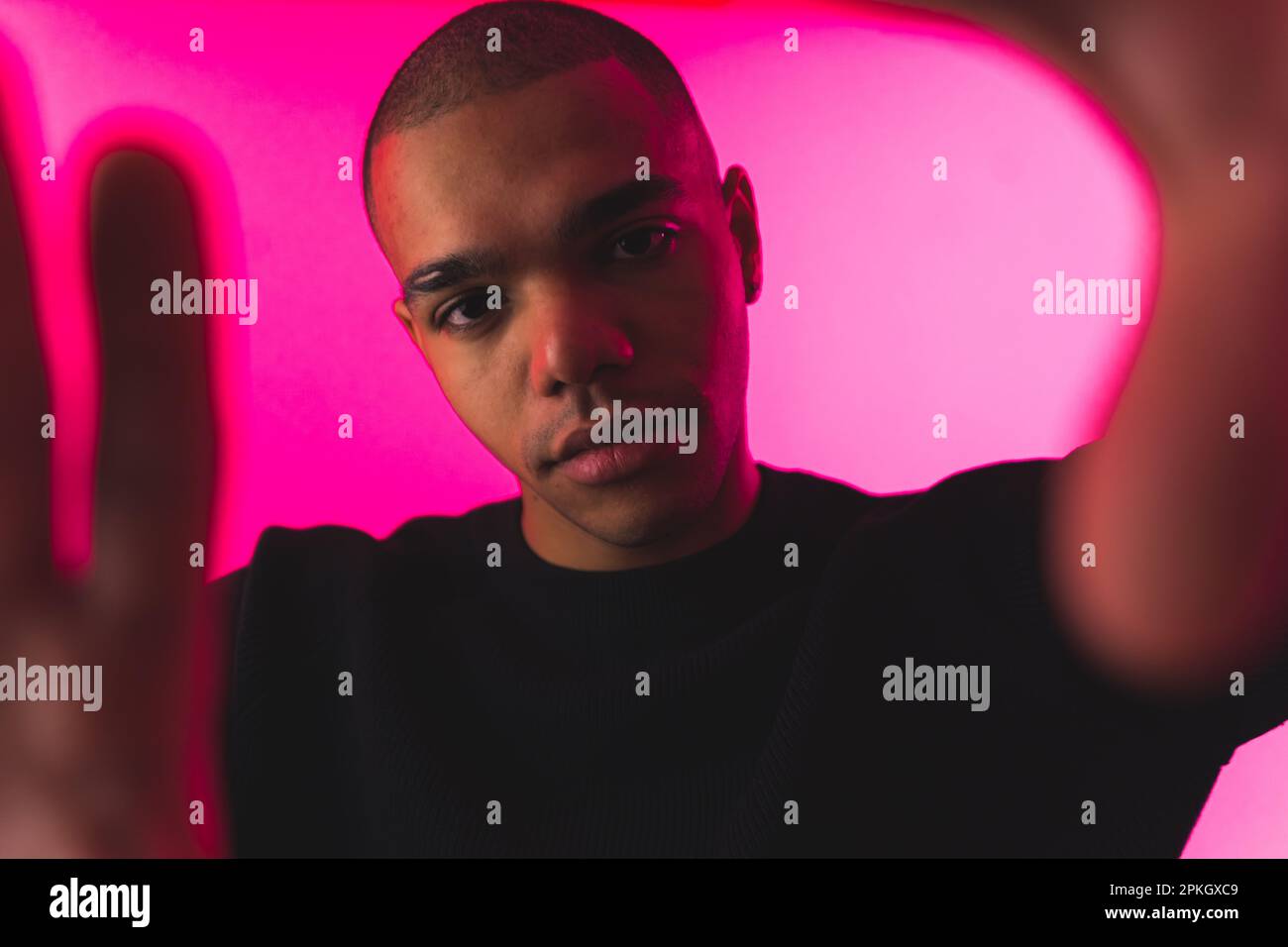 Camera frame concept. Young adult man covering camera with two hands in ...