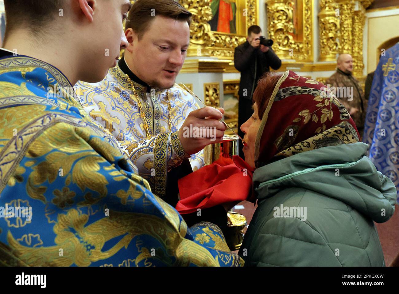 KYIV, UKRAINE - APRIL 07, 2023 - A woman receives communion from the ...