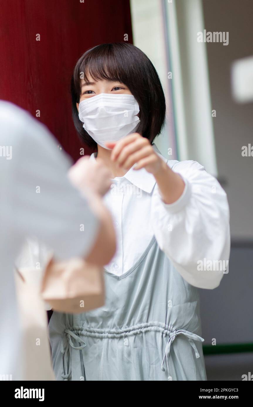 Receiving food delivery at front door hi-res stock photography and ...