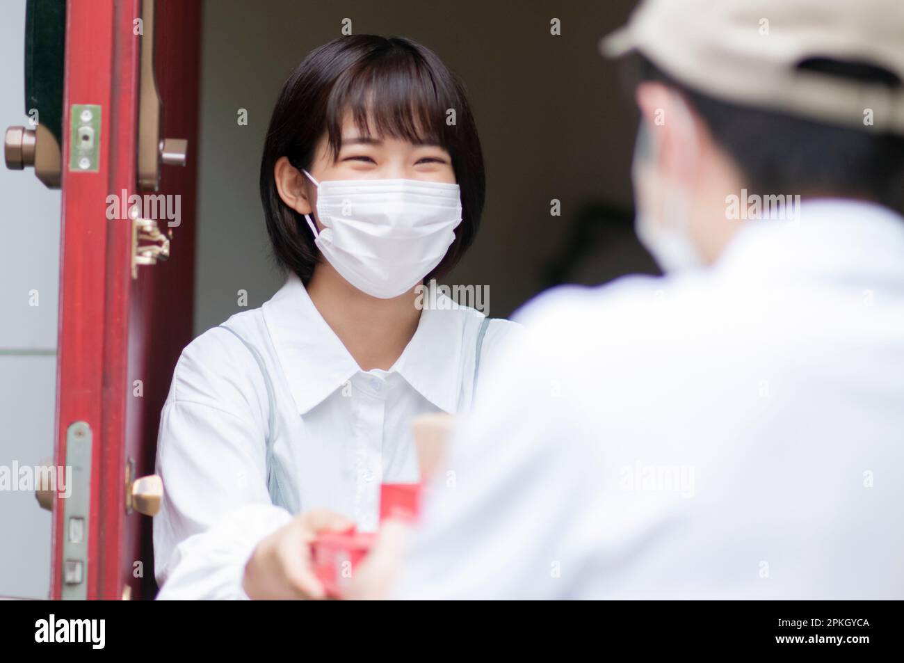Young woman receiving delivery Stock Photo - Alamy