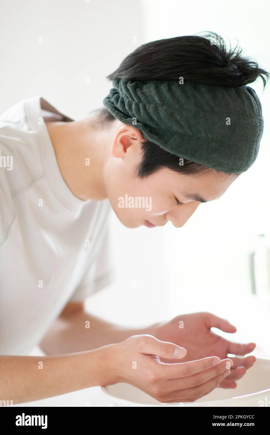 Young man washing face Stock Photo - Alamy