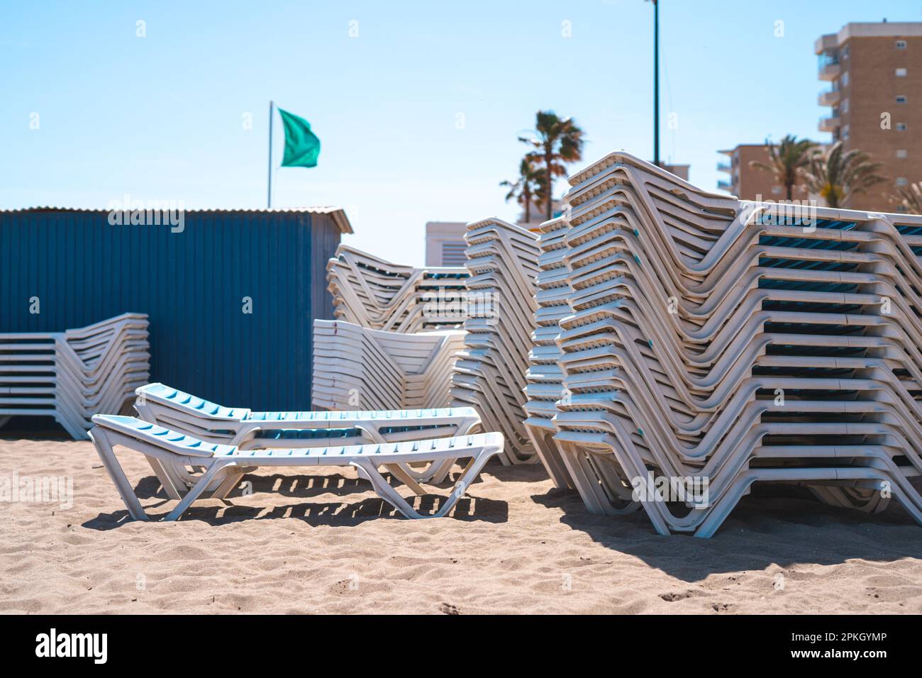 sun loungers stacked on the sand on the beach Stock Photo - Alamy