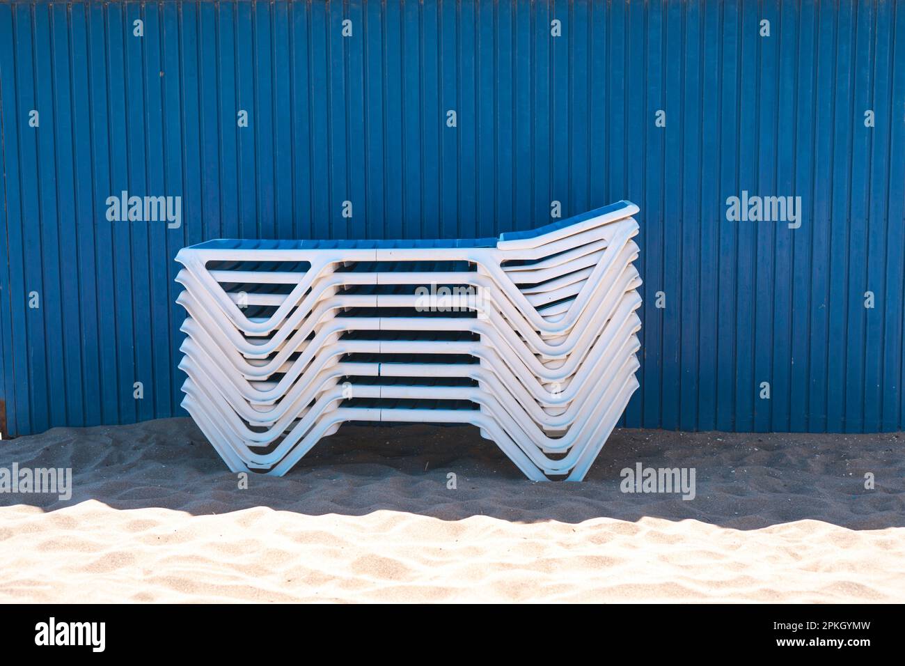 sun loungers stacked on the sand on the beach Stock Photo - Alamy