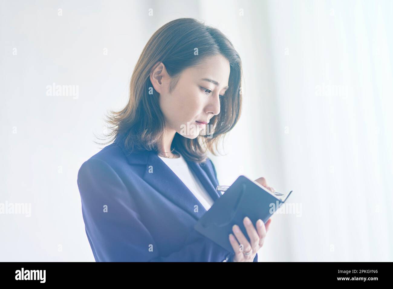 Woman taking notes seriously while standing Stock Photo - Alamy