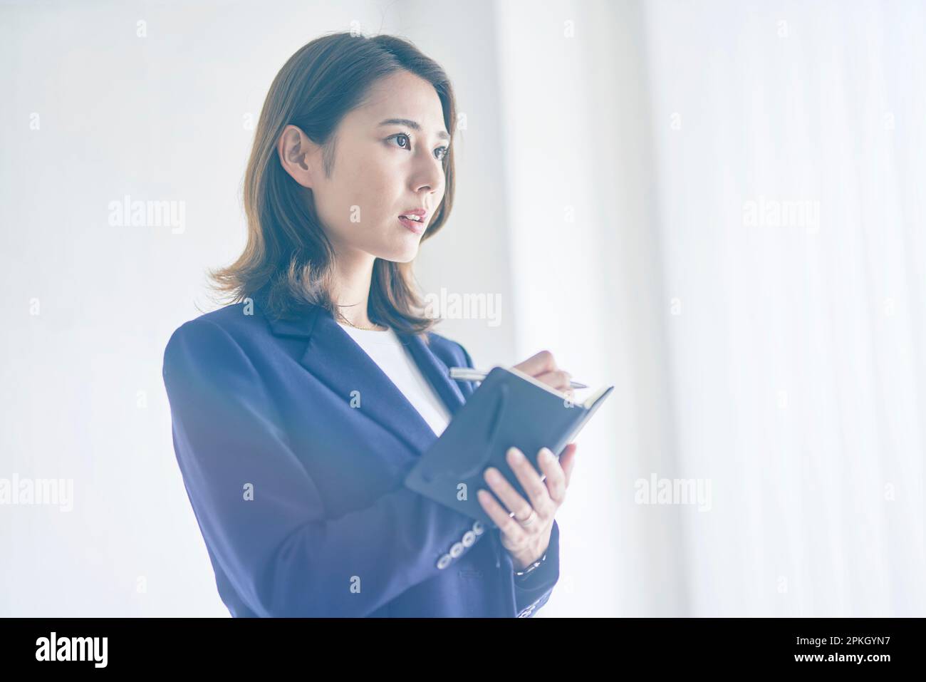 Woman taking notes seriously while standing Stock Photo - Alamy