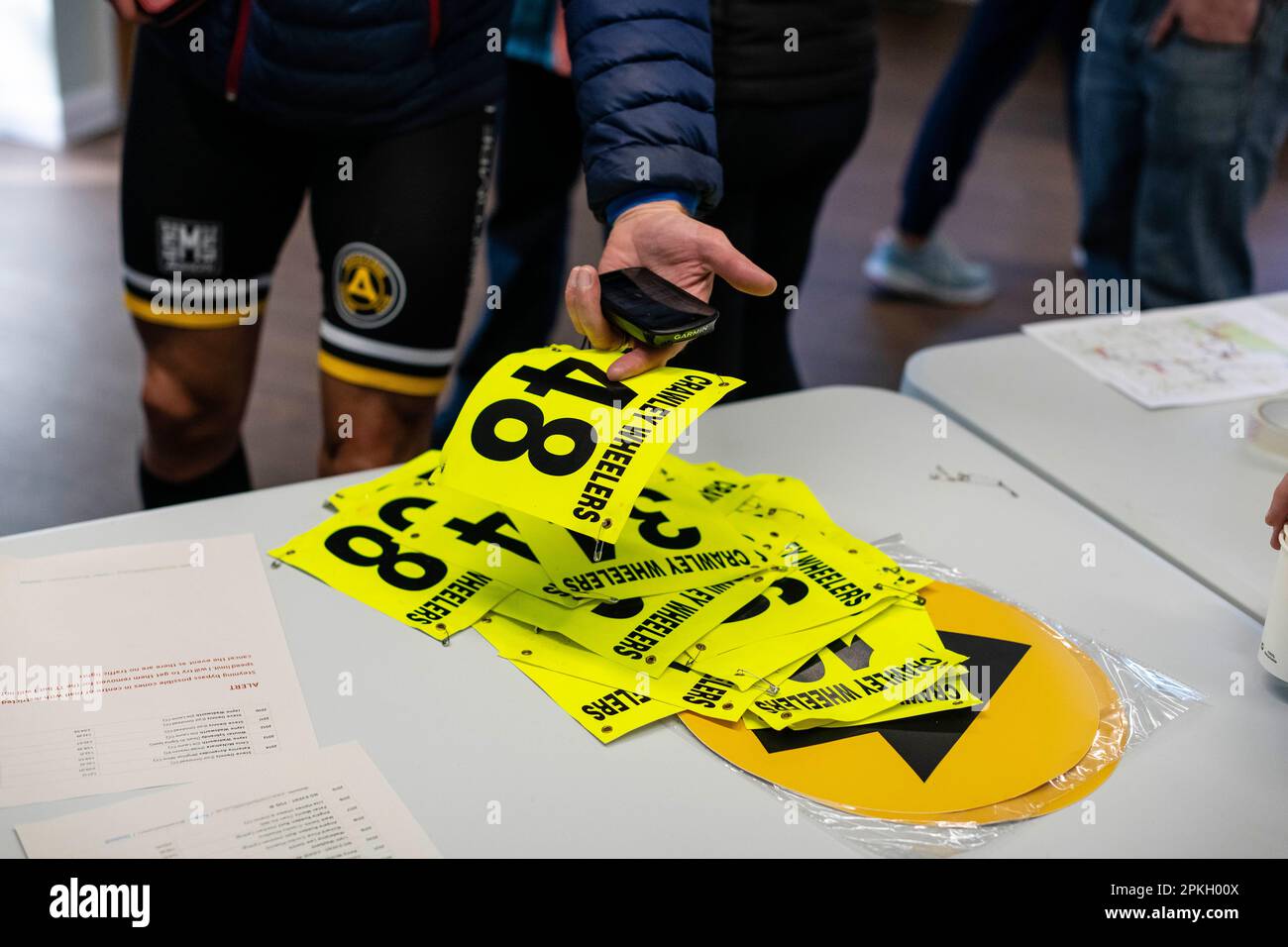 Bike racer collecting number Stock Photo - Alamy