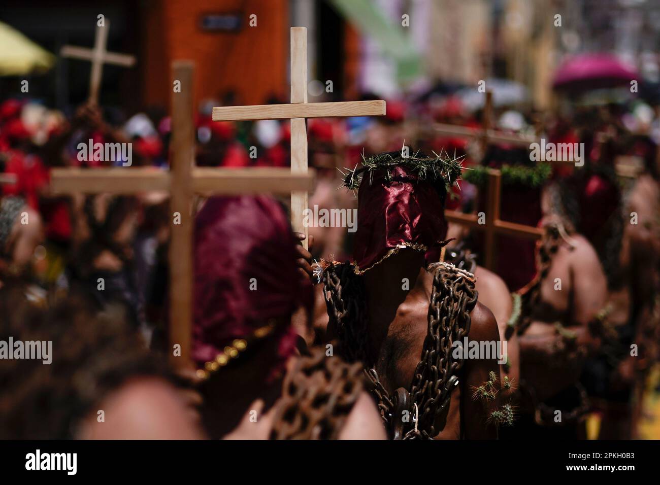 Masked penitents, in chains with cacti stuck to their skin, march ...