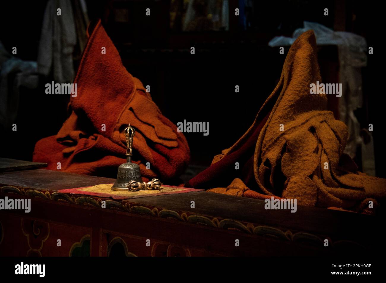 Empty cloaks, Vajra and Bell in the prayer hall at Stongdey Monastery ...