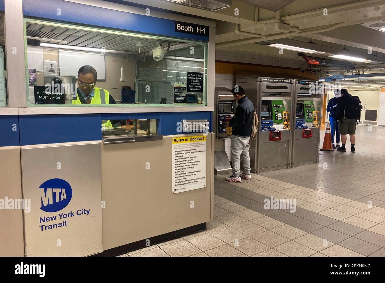 A station agent is inside a subway token booth in New York City on ...