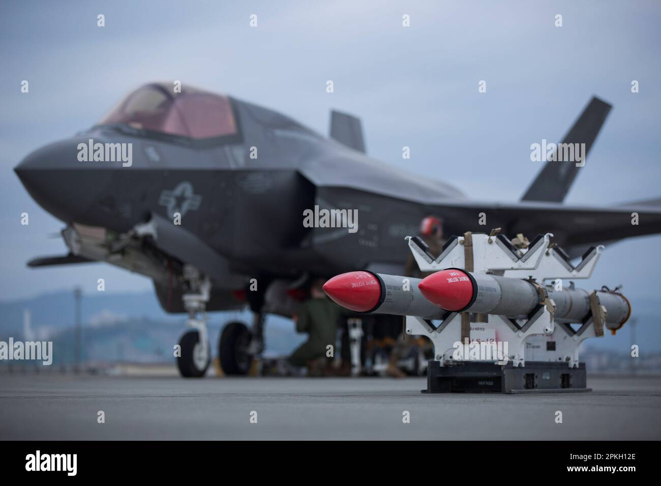 U.S. Marines with Marine Fighter Attack Squadron 242 load AIM-120 ...