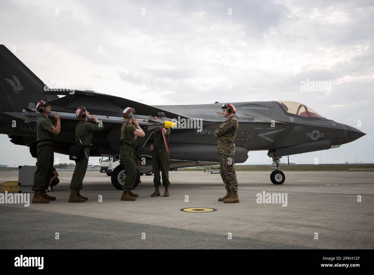 U.S. Marines with Marine Fighter Attack Squadron 242 mount an AIM-9X ...