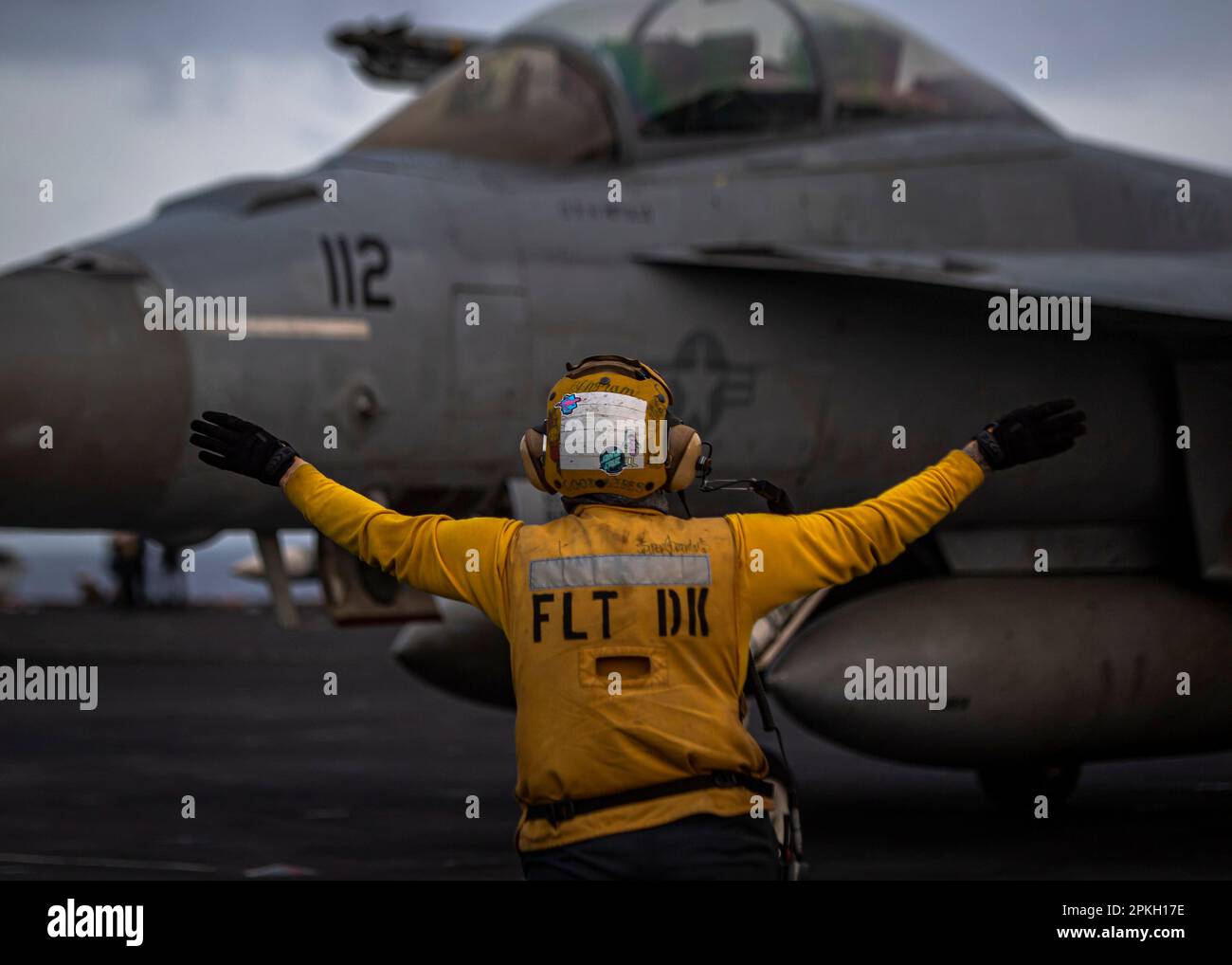 230406-N-MH015-2035 EAST CHINA SEA (April 6, 2023) A U.S. Navy Sailor directs an F/A-18F Super ...
