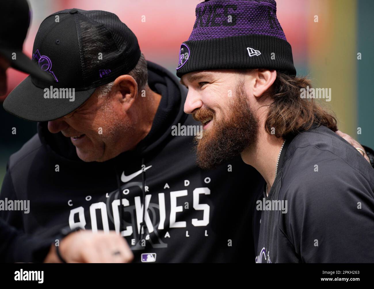 Injured Colorado Rockies second baseman Brendan Rodgers, right, jokes ...