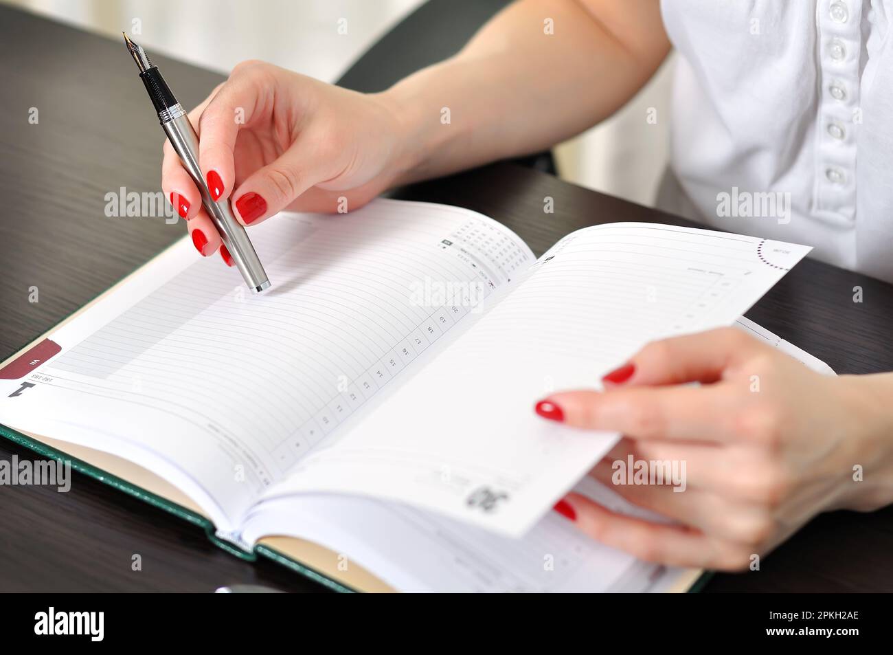 Woman holding pen reading book hi-res stock photography and images - Alamy