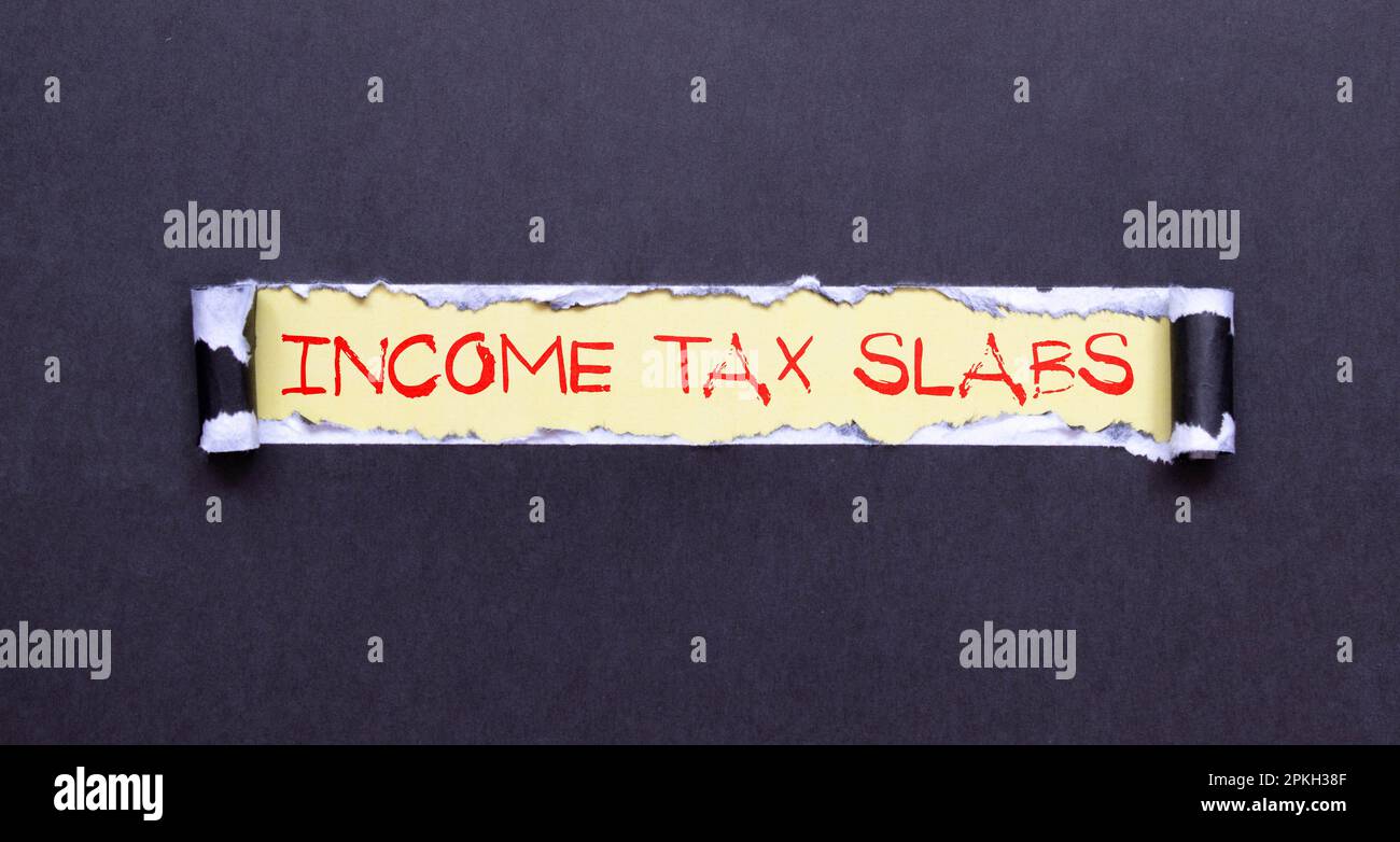 Income Tax Slabs inscription on white card. Workplace background, top ...