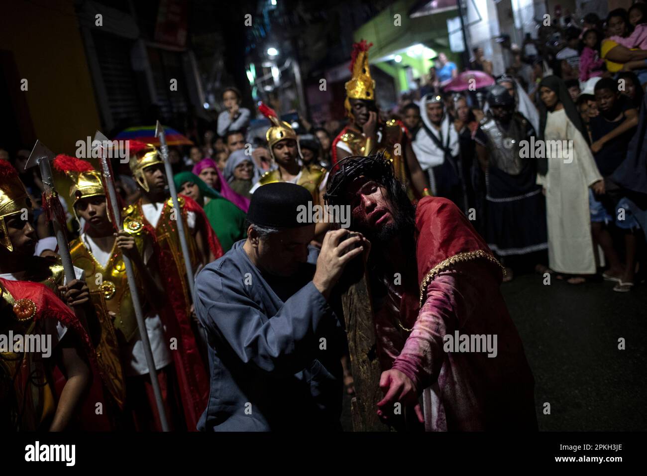 A devotee steps in to help Luiz Henrique, playing the role of Jesus ...