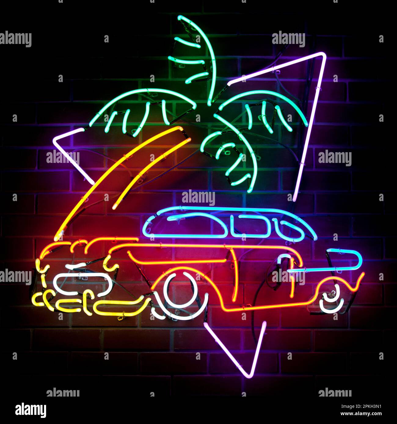 Close up on a neon light shaped into an old chevy under a palm tree ...