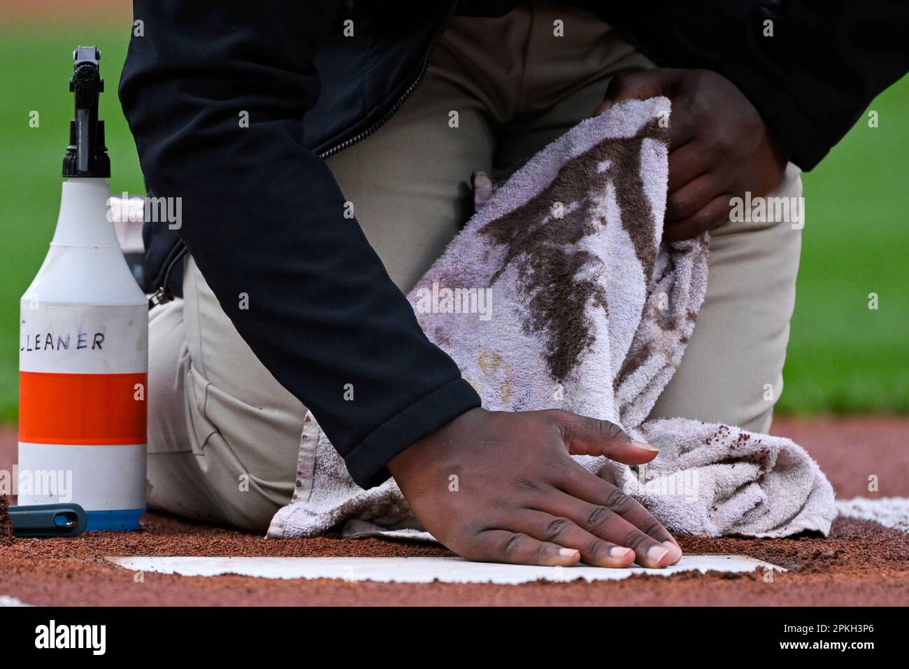 A member of the Camden Yards grounds crew cleans home plate before an ...